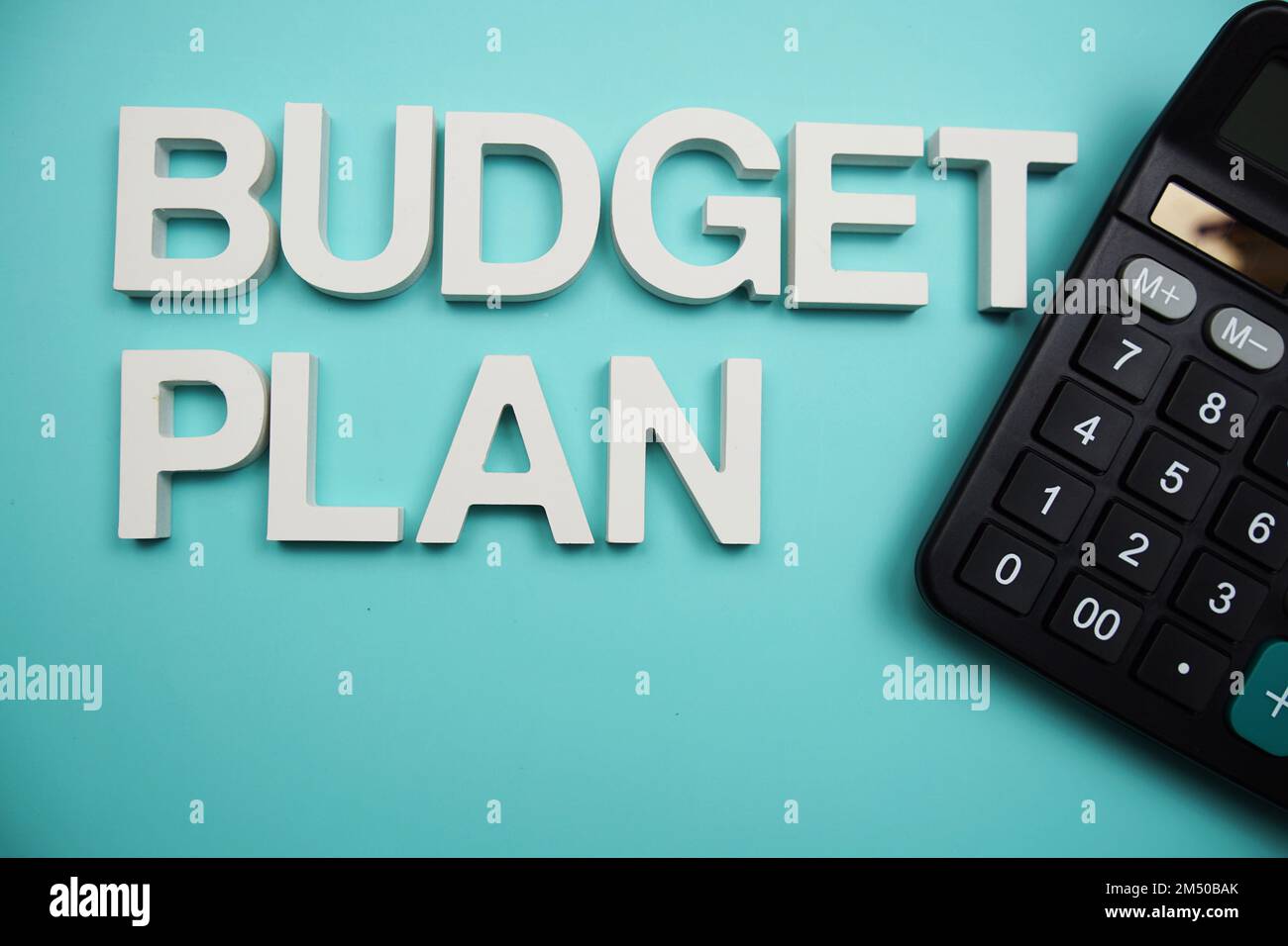 Budget Plan alphabet letters with calculator on blue background Stock ...