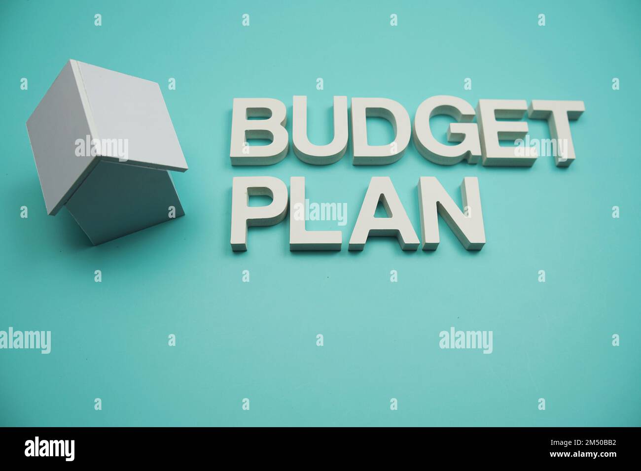 Budget Plan alphabet letters with House Model on blue background Stock ...