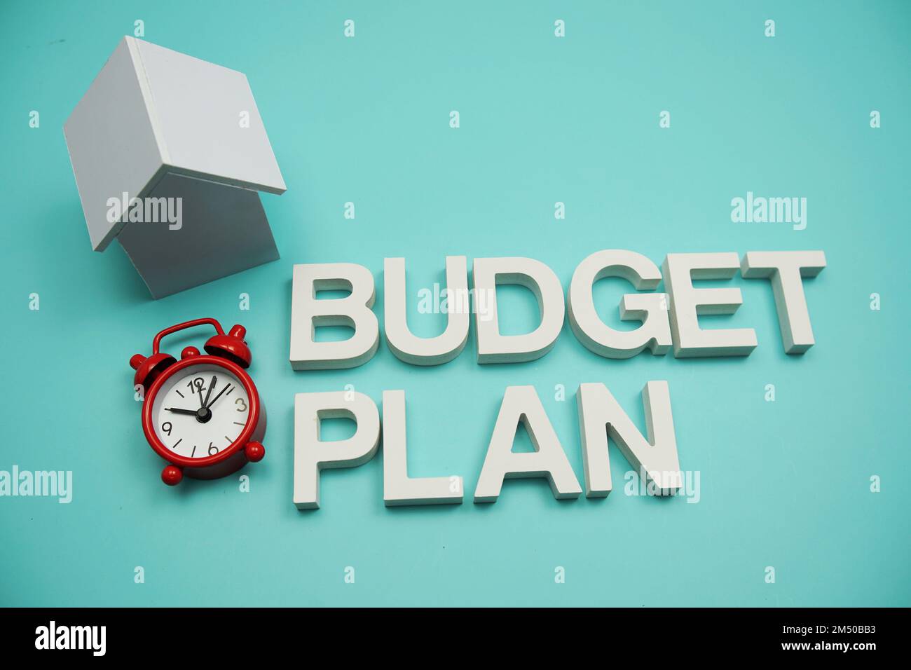 Budget Plan alphabet letters with House Model and Clock on blue ...