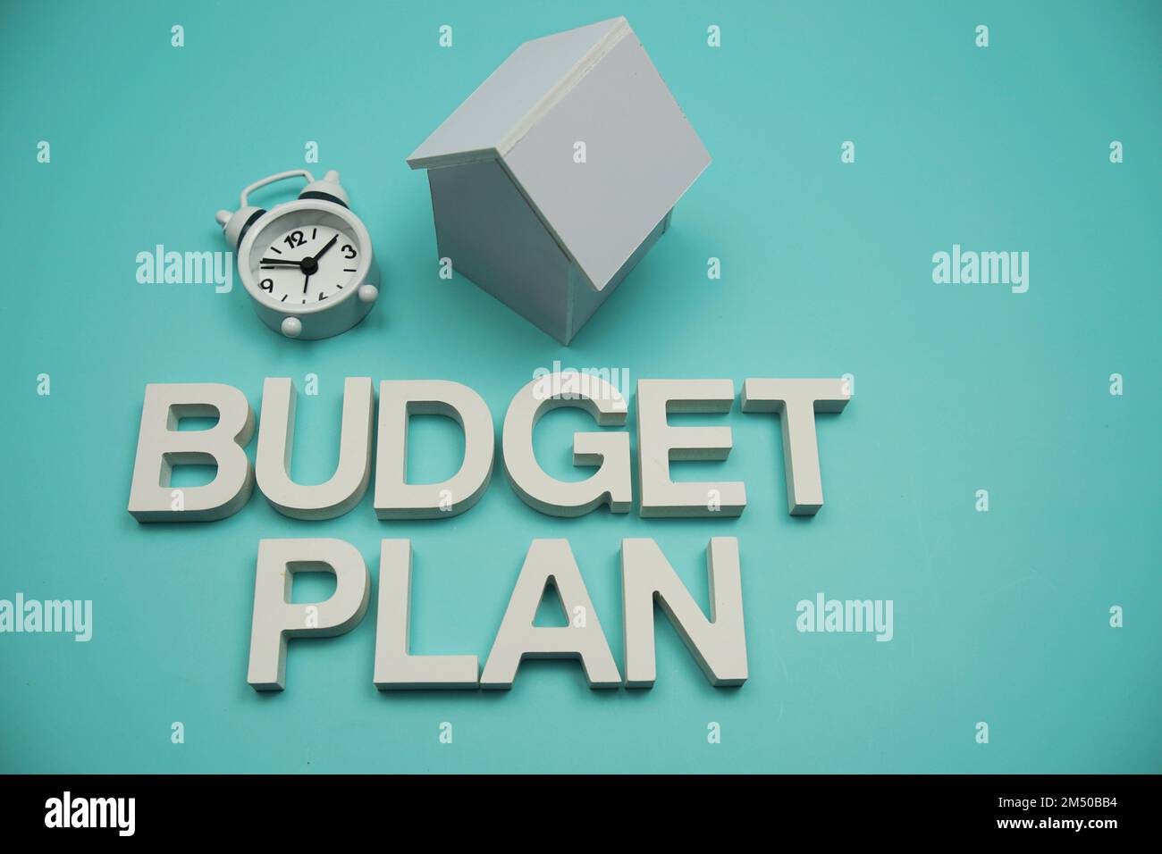 Budget Plan alphabet letters with House Model and Clock on blue ...