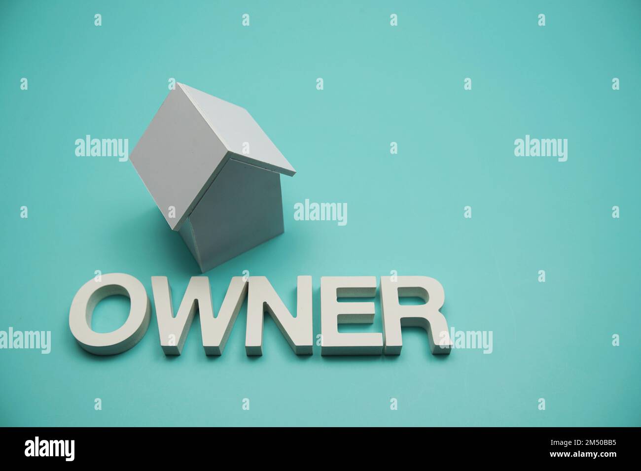 Owner alphabet letters with House model on blue background Stock Photo ...