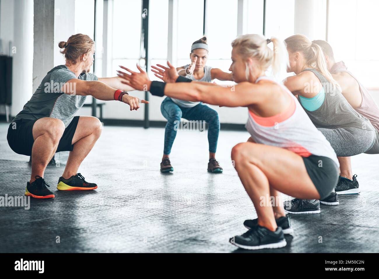 Look at how shes doing it. a fitness group working out at the gym Stock ...