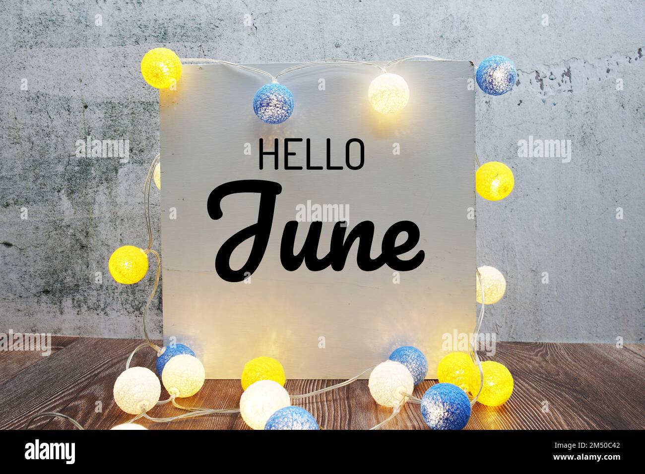 Hello June text message with LED cotton ball decoration on wooden ...