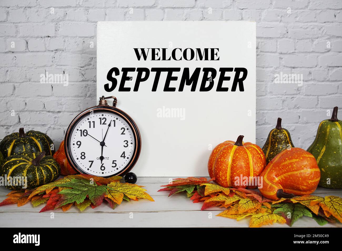 Welcome September text message with pumpkin and maple leaf decoration ...