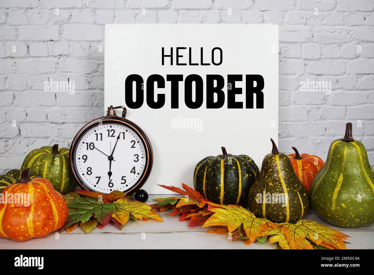 Hello October text message with pumpkin and maple leaf decoration on ...