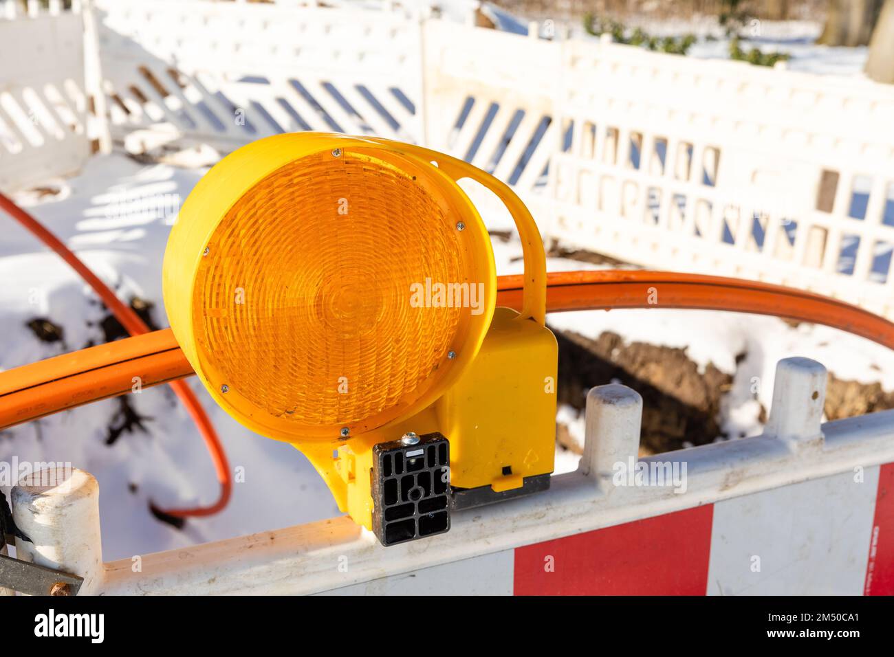 A closeup shot of a road blocking signs on a snowy field, with an ...