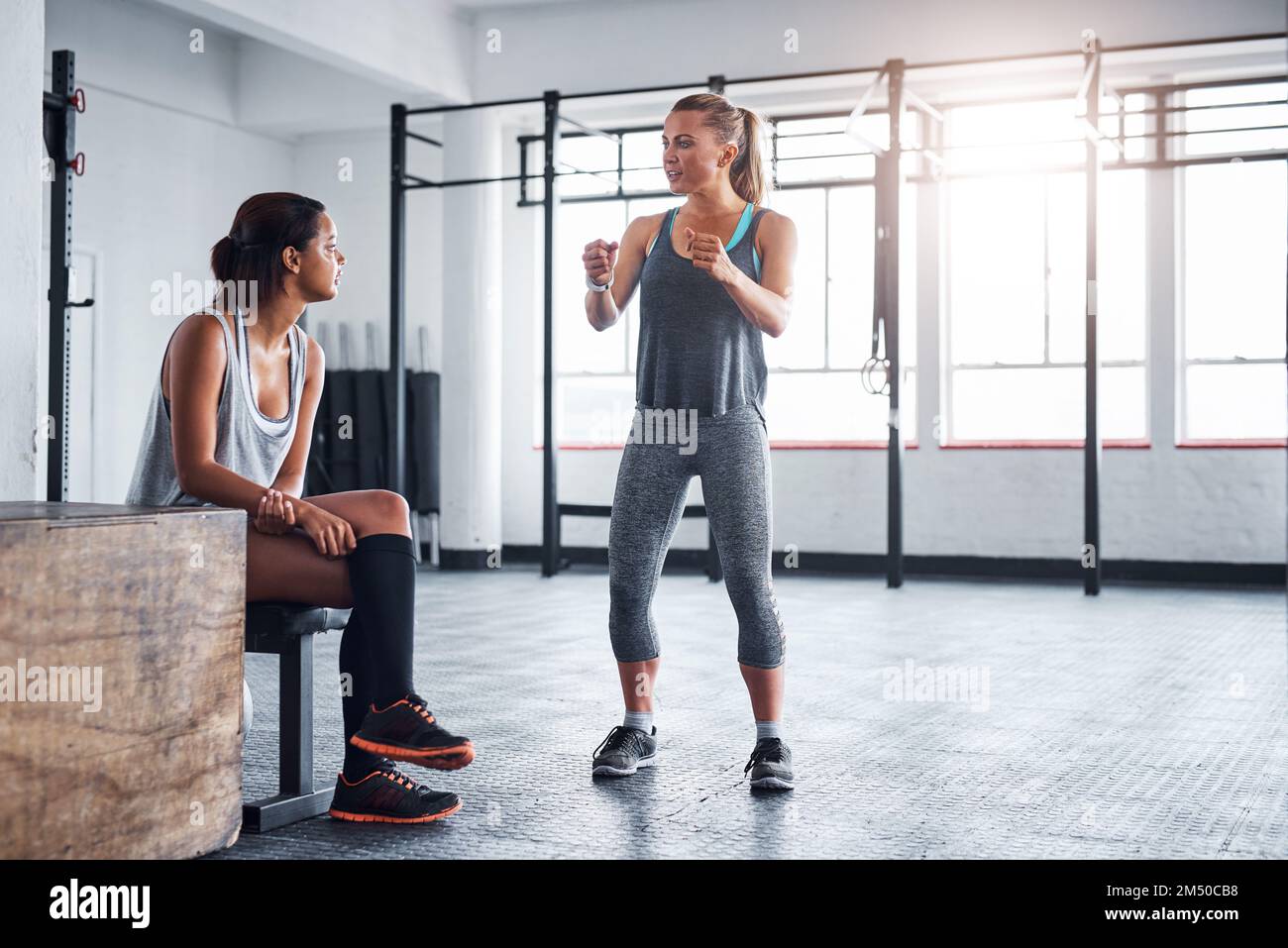 Get ready to engage. a fitness instructor talking to her client in a ...