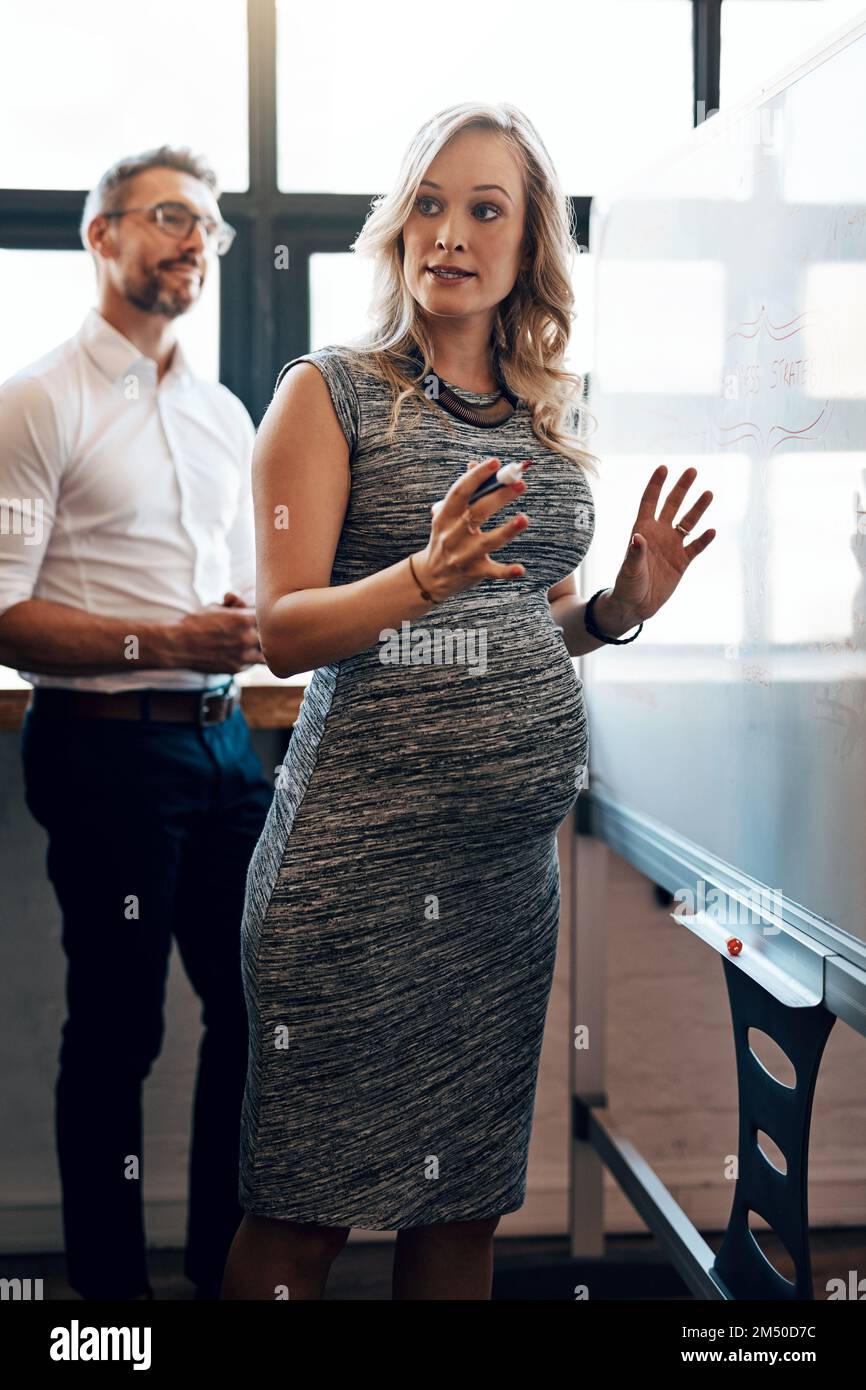 Making sure her team is prepared for her absence. a pregnant ...