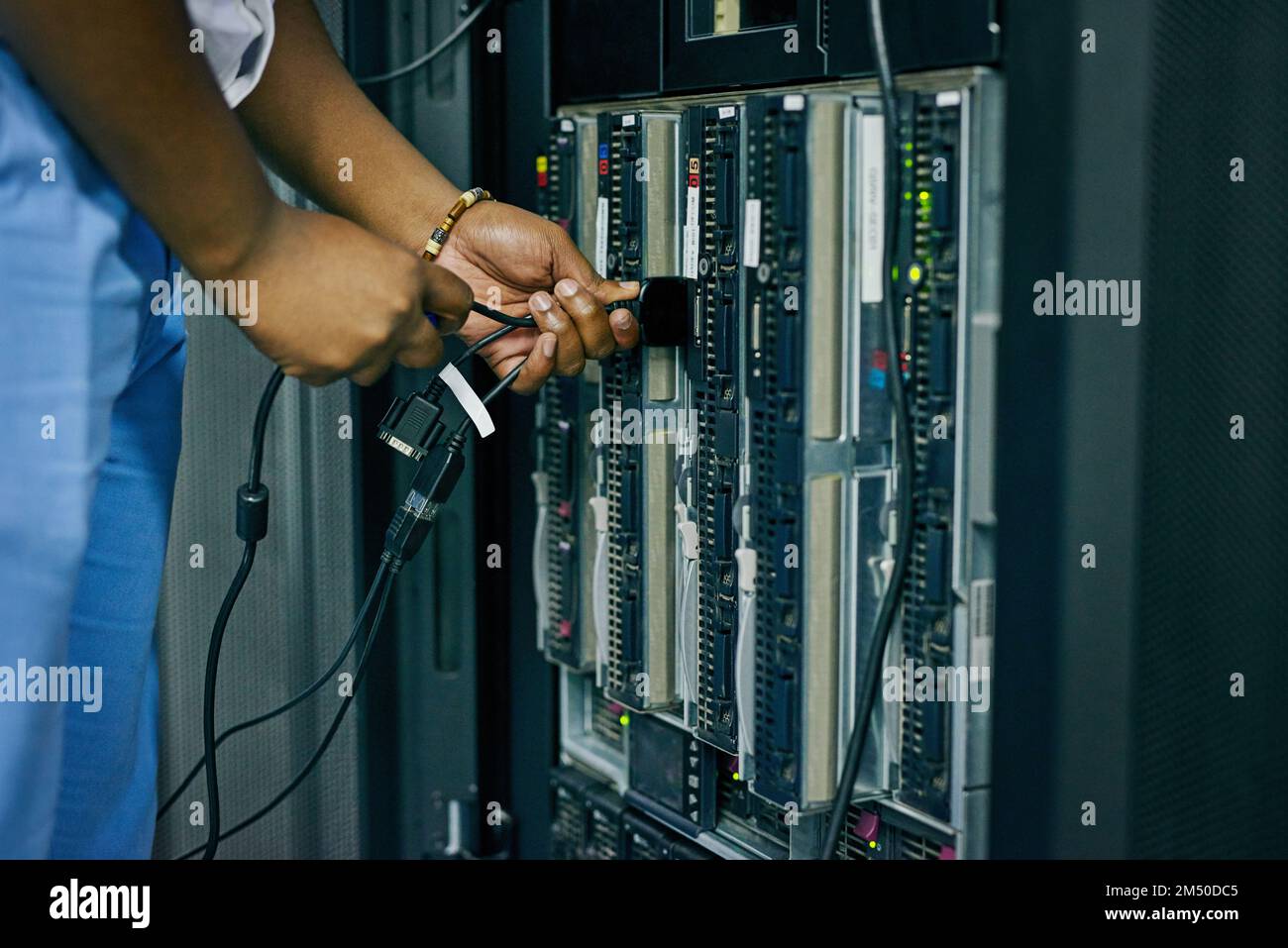 Plugged in to professional IT administration. an IT technician plugging ...