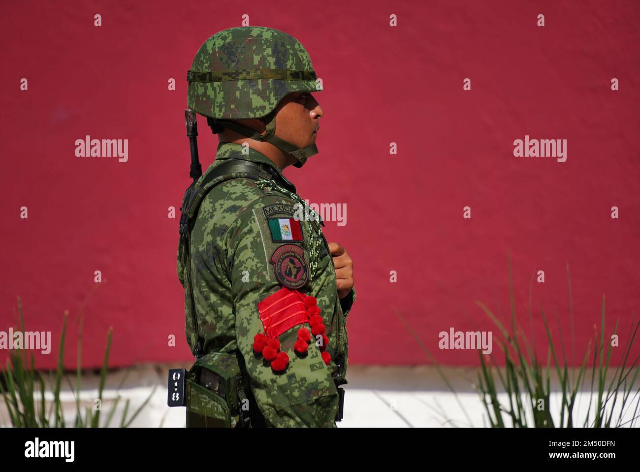 A closeup of a Mexican soldier in combat helmet and camouflage during a ...