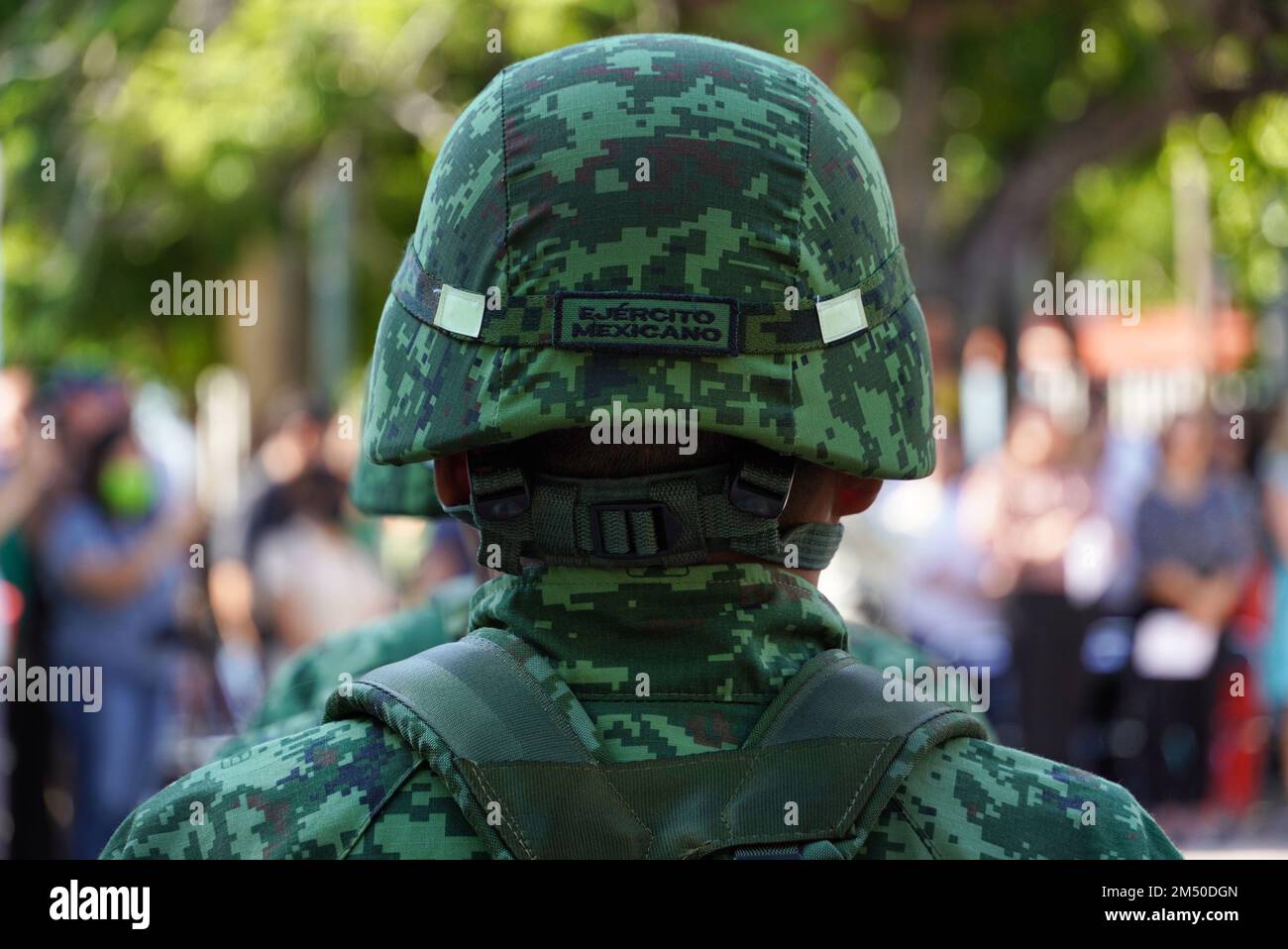 A closeup of a Mexican soldier in combat helmet and camouflage during a ...