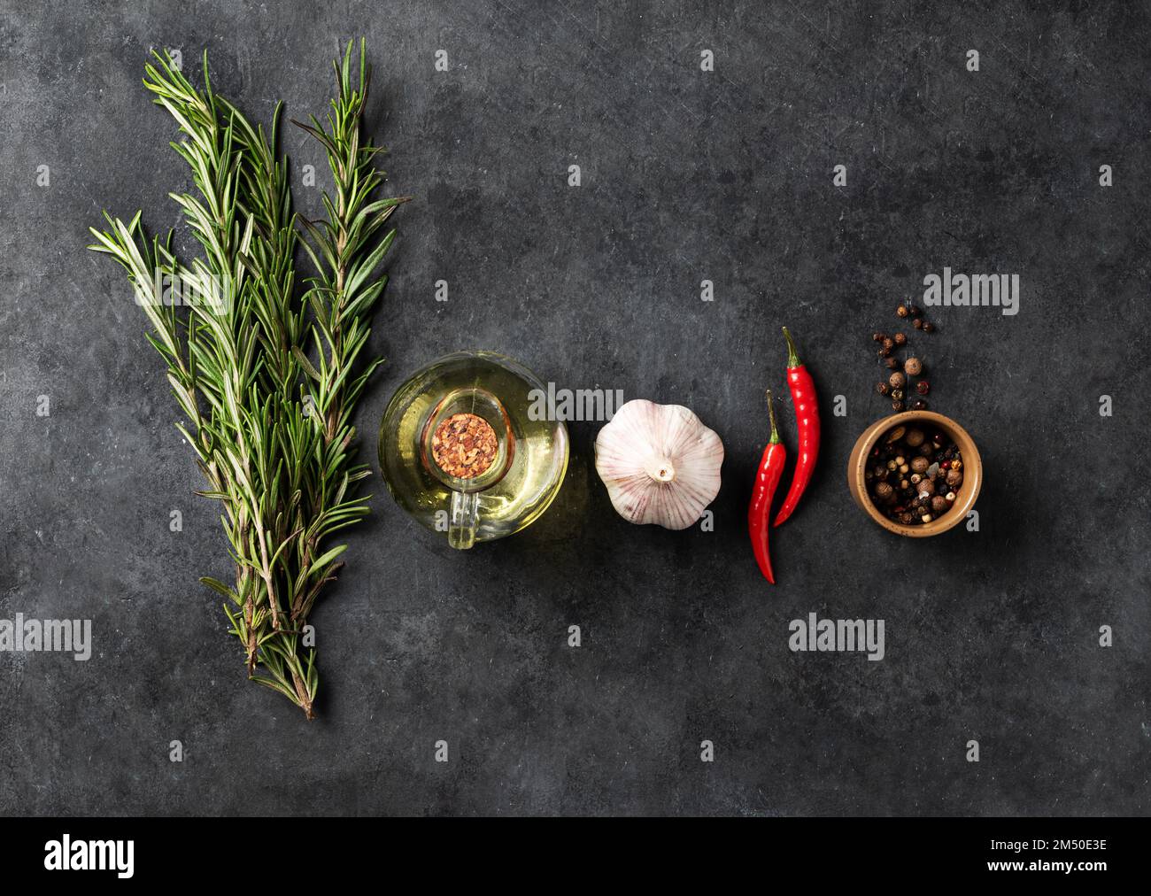 Flat lay of spices and fresh herbs rosemary, garlic, pepper, chili ...