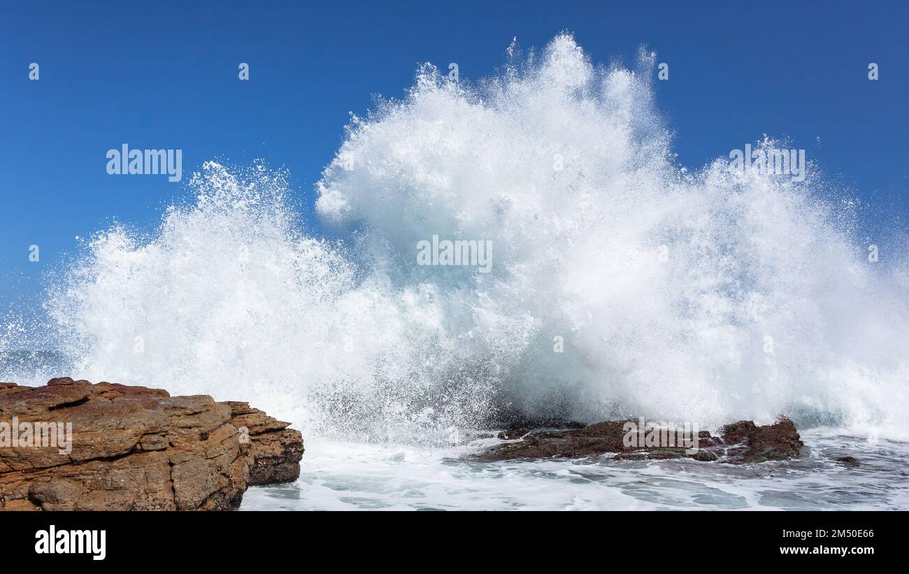 Wave rocks crashing exploding white ocean sea water spray power into ...