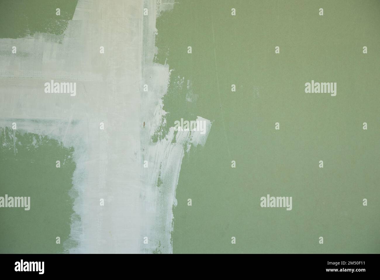 drywall wall of green color as a background Stock Photo - Alamy