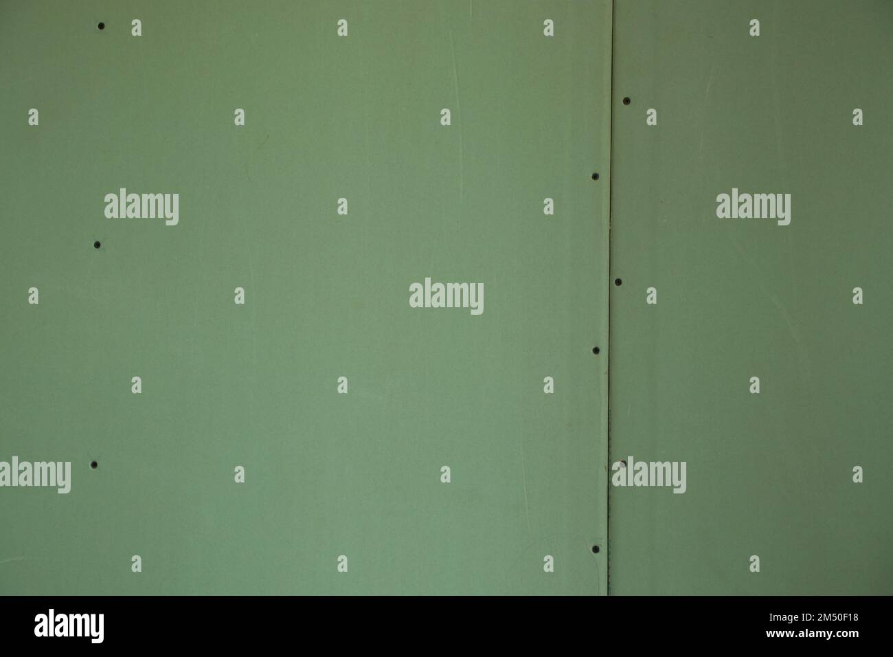drywall wall of green color as a background Stock Photo - Alamy