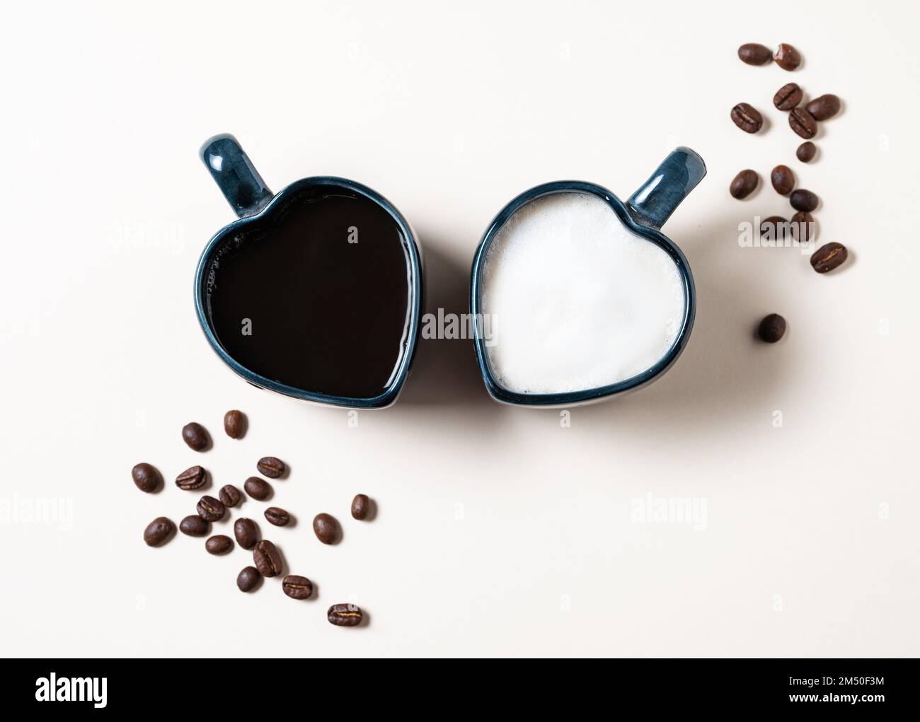 Two cups in the form of hearts with freshly brewed aromatic coffee with ...