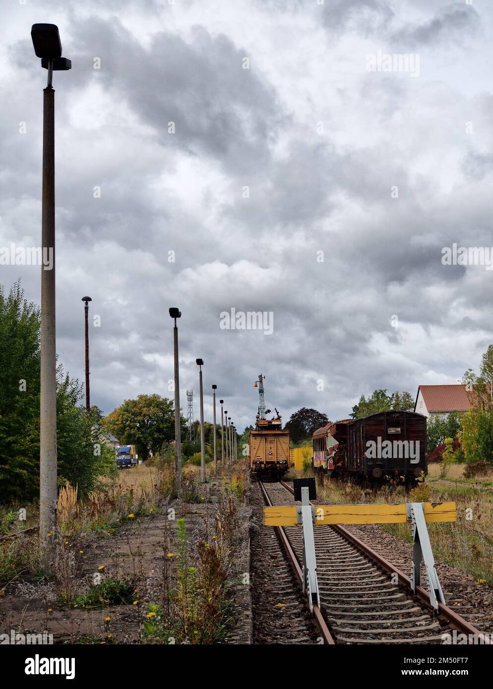 A closed railroad with cloudy sky on the background Stock Photo - Alamy