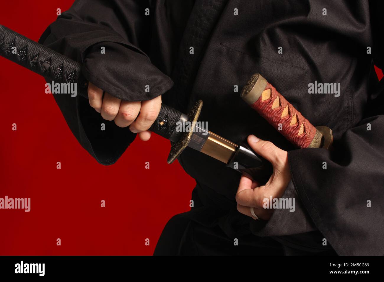 Man Removing Japanese Katana Sword From Scabbard Stock Photo - Alamy