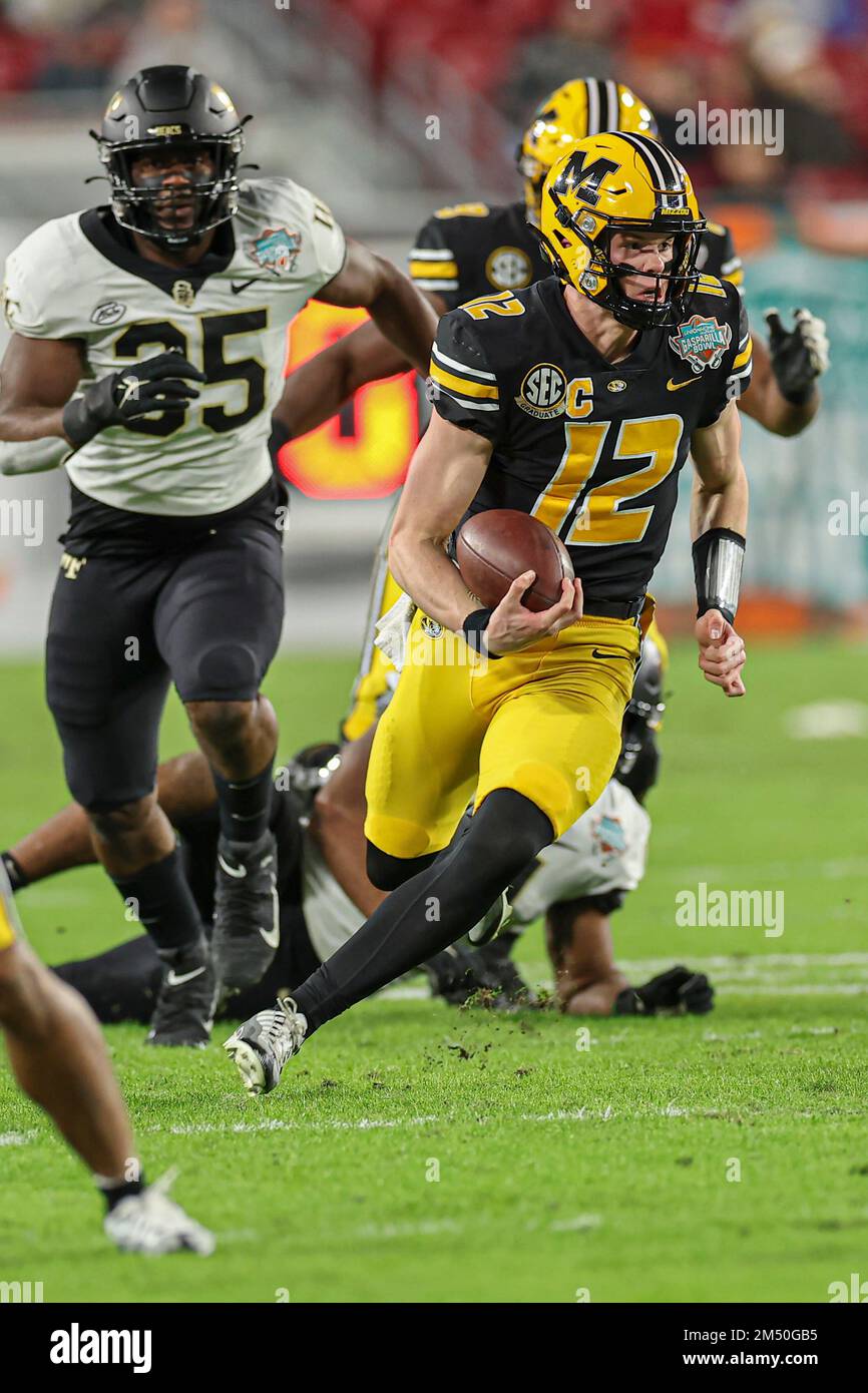 Tampa Bay, FL USA; Missouri Tigers quarterback Brady Cook (12) runs ...