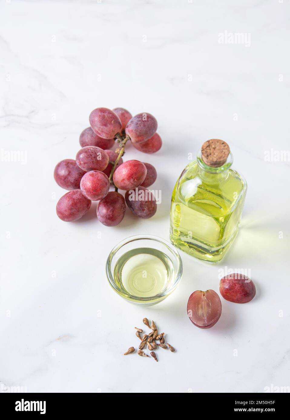 Natural vegetable oil from grape seeds in a clear bottle on the kitchen ...