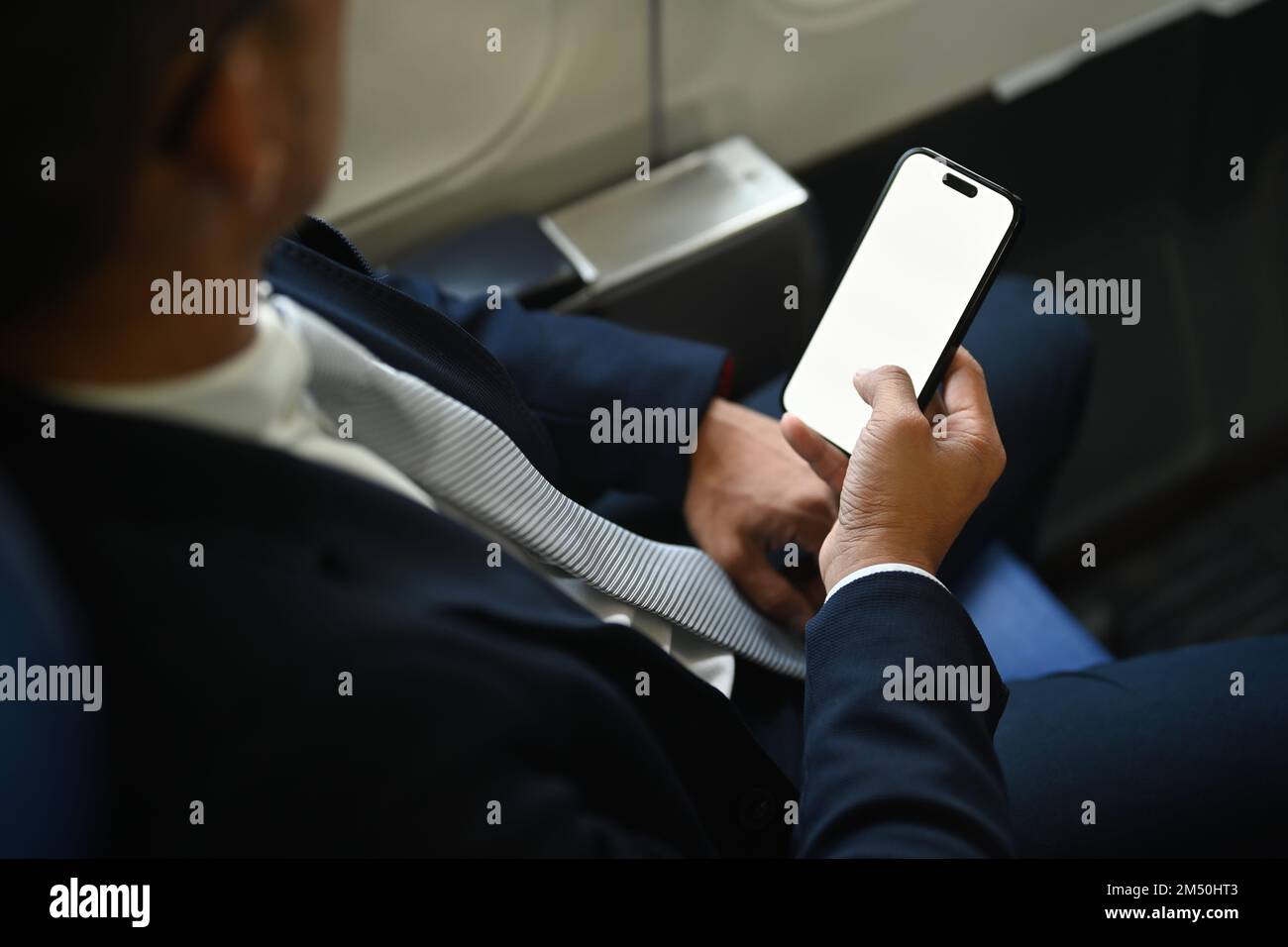 Businessman checking work, news on smart phone, using wireless ...