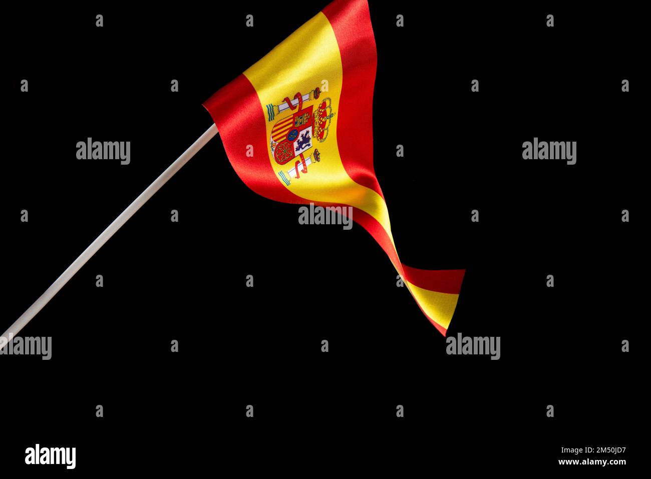 The Spanish flag on a black background developing and fluttering in the ...