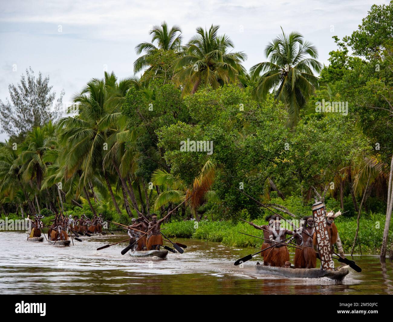 Canoe welcome to the Pem Village in the Asmat region of South Papua ...