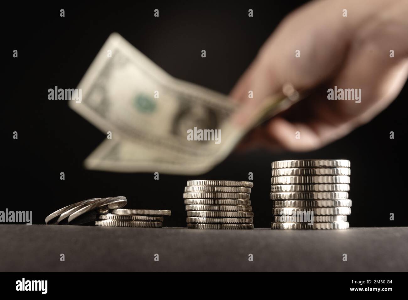 Social Assistance in the United States. Coins and hand with dollars on ...