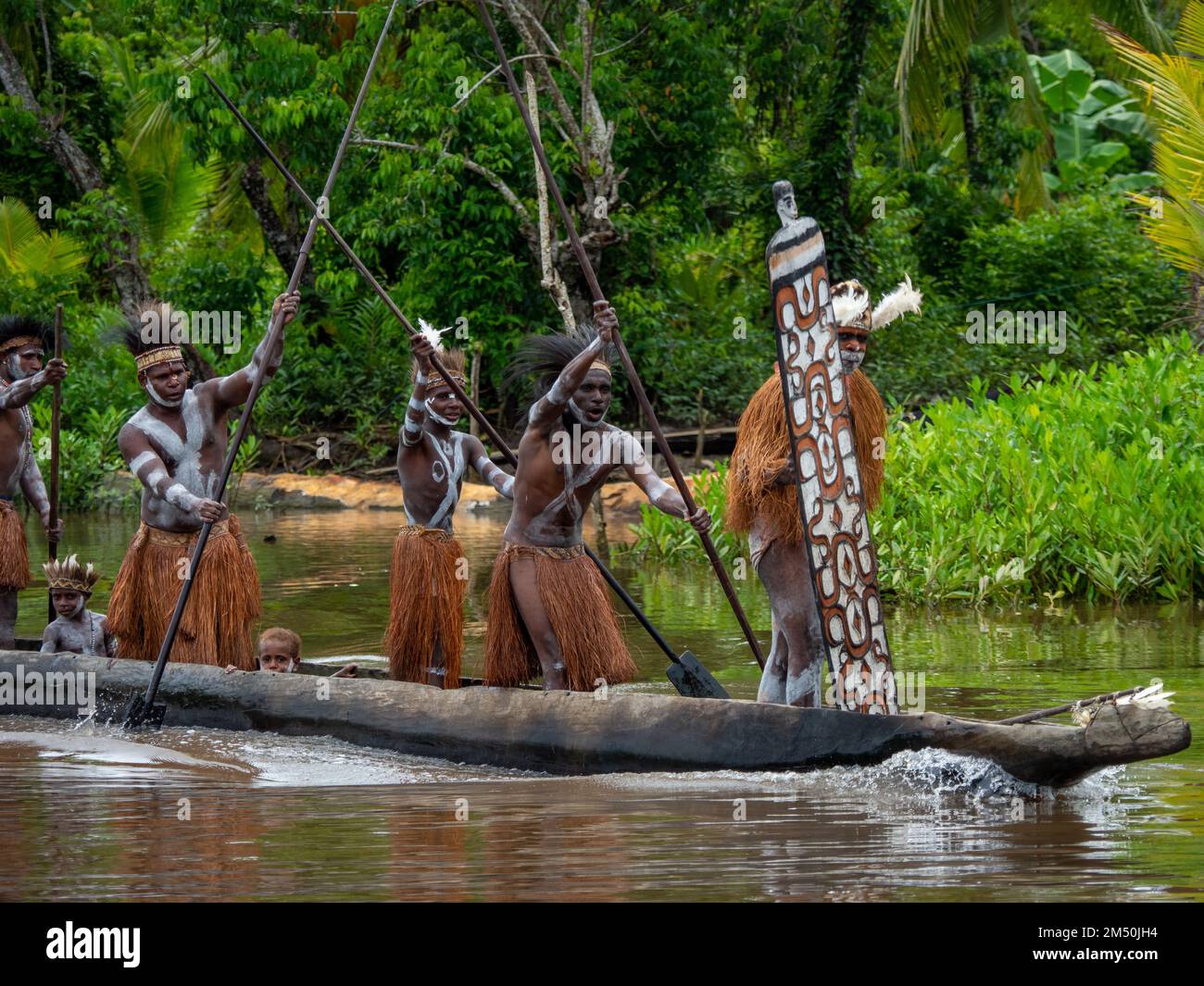 Canoe welcome to the Pem Village in the Asmat region of South Papua ...