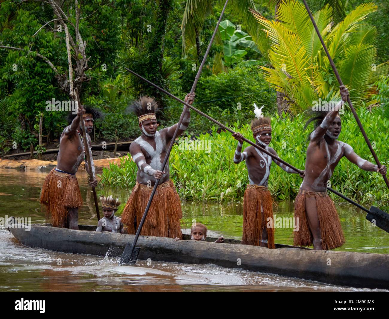 Canoe welcome to the Pem Village in the Asmat region of South Papua ...