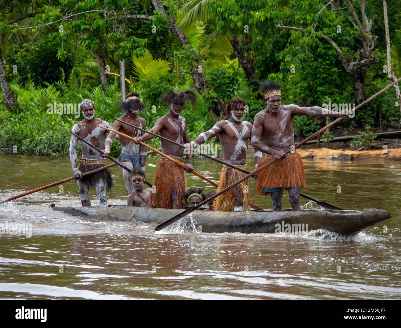 Canoe welcome to the Pem Village in the Asmat region of South Papua ...