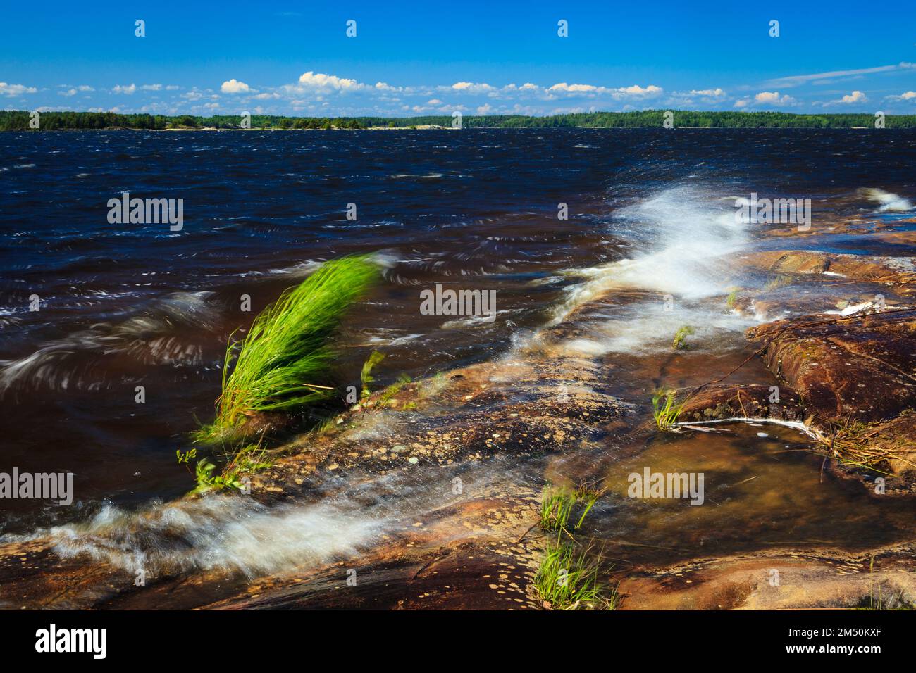 Windy summer day with waterspray, sunny weather and blue sky at the ...