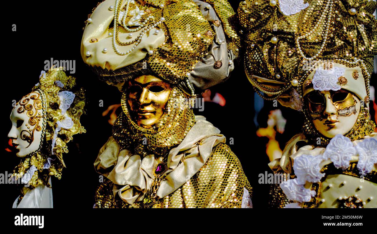golden masks stroll through the Carnival Stock Photo - Alamy