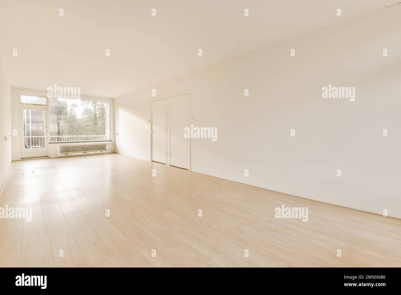 an empty living room with wood flooring and white walls in the room is ...