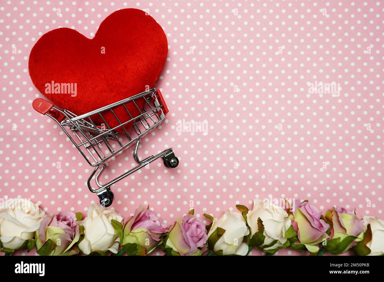 Red Heart and Mini Trolley Shopping Cart on Pink polka dot background ...