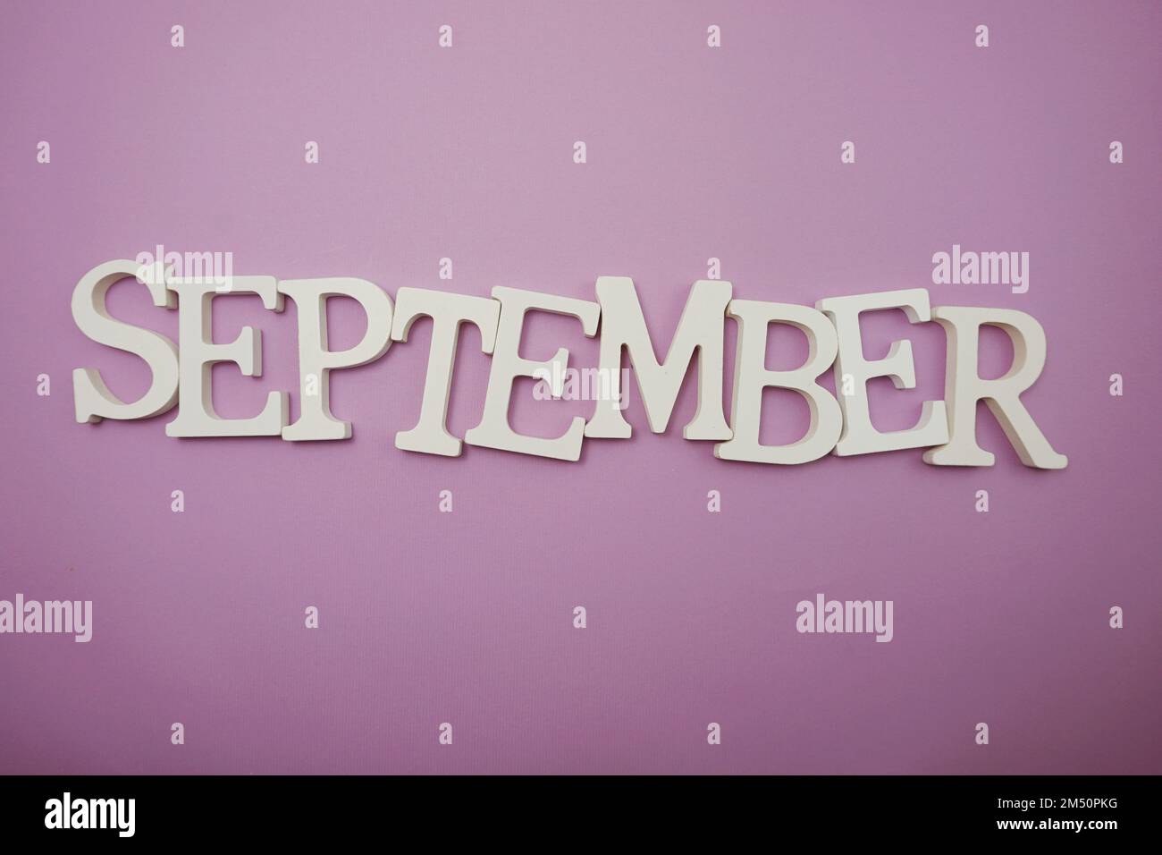 September alphabet letters on purple background Stock Photo - Alamy