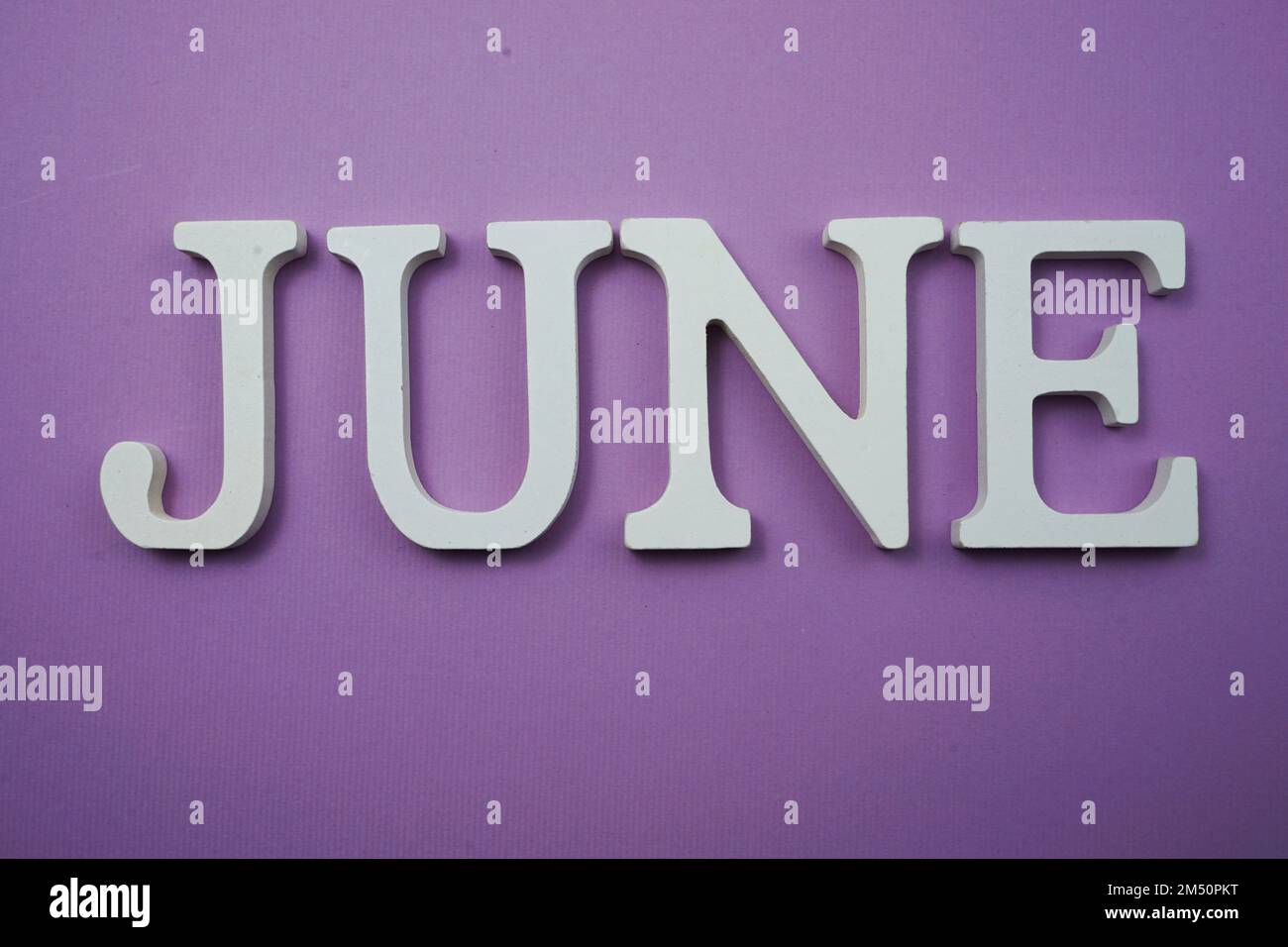 June alphabet letter with space copy on purple background Stock Photo ...