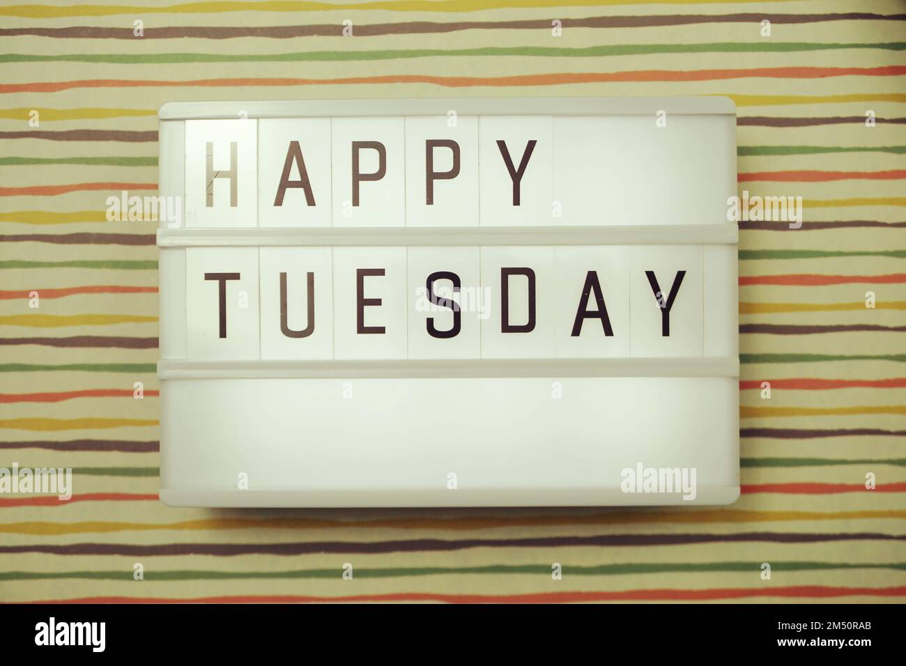 Happy Tuesday text in lightbox with space copy flat lay on colorful ...