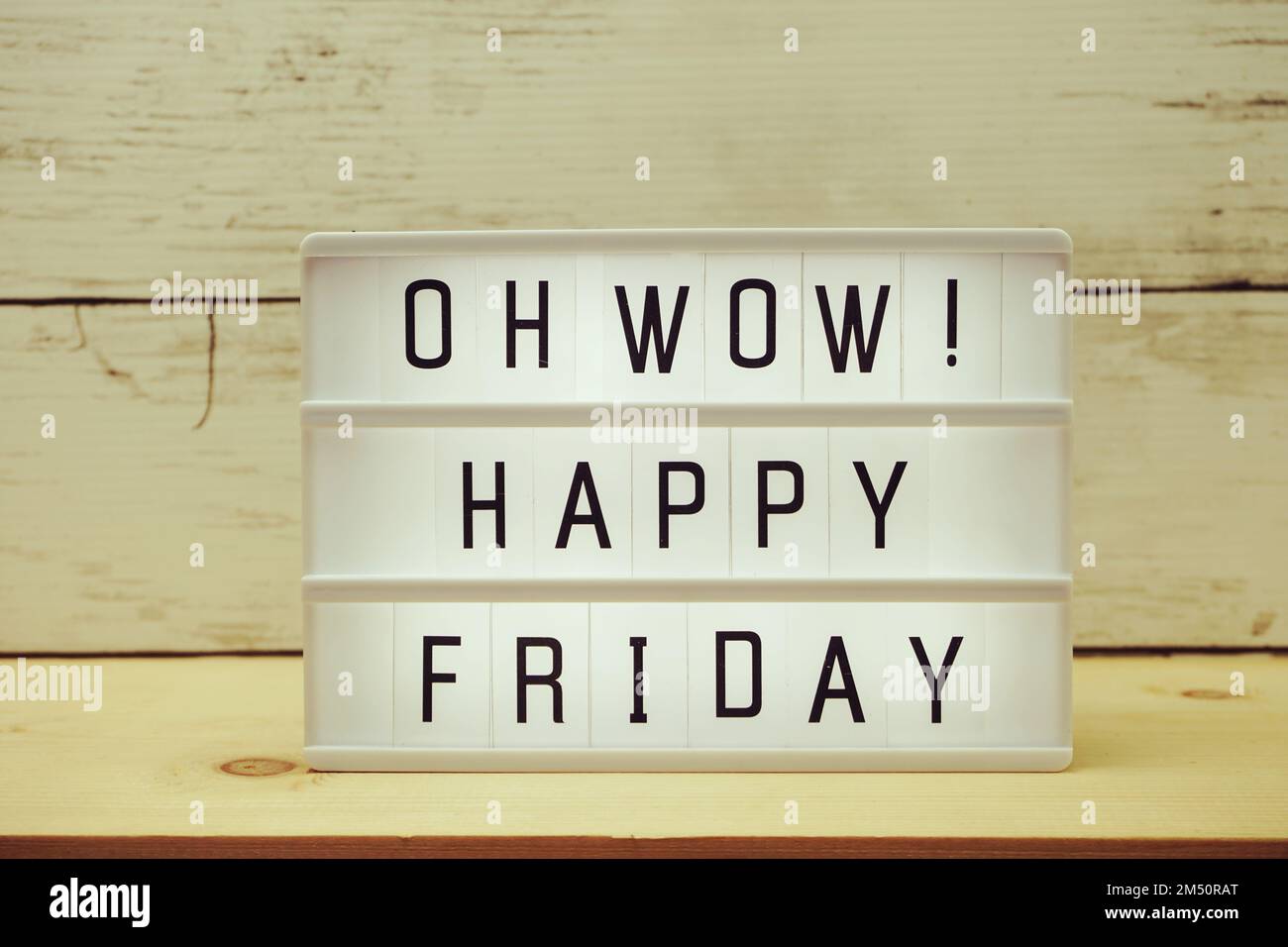 Happy Friday text in lightbox with space copy on wooden background ...