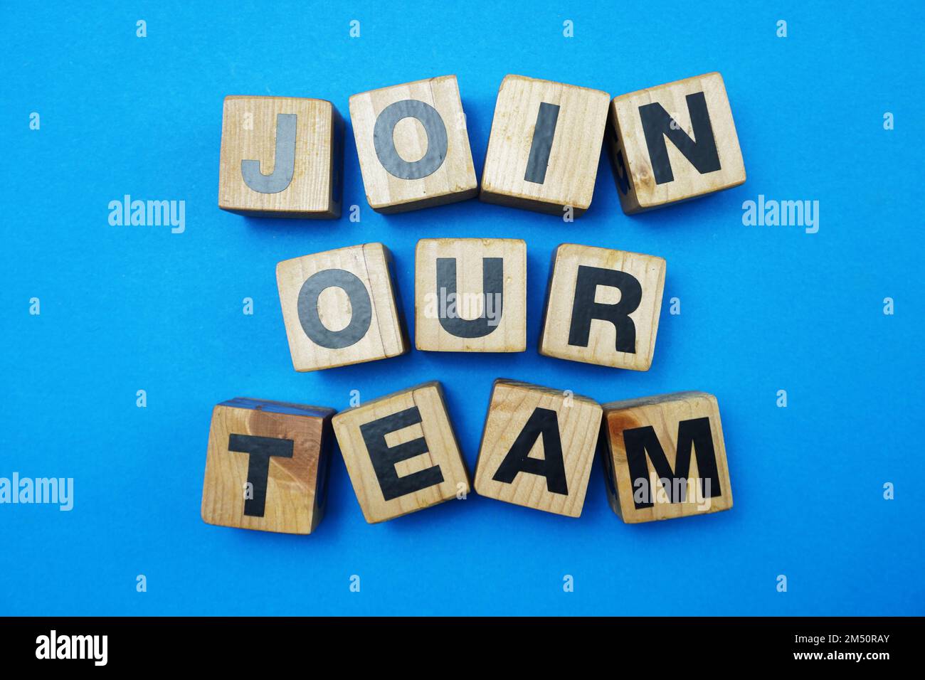Top view Join our team alphabet letters on blue background Stock Photo ...