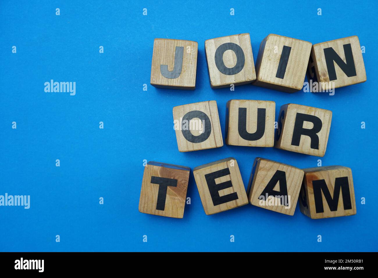 Top view Join our team alphabet letters on blue background Stock Photo ...