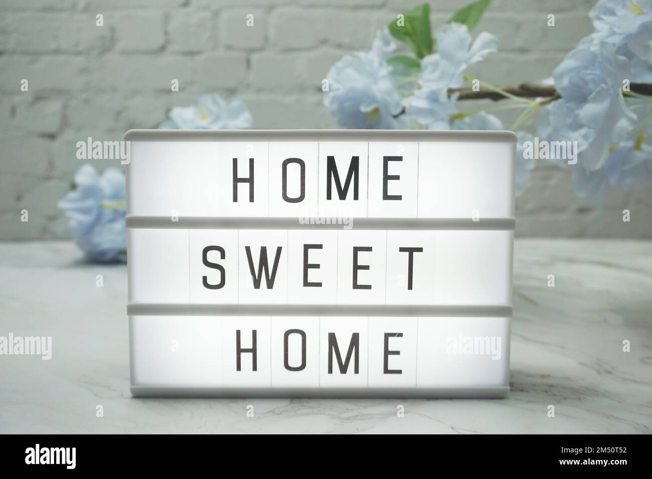 Home Sweet Home Word in light box with flowers decoration Stock Photo ...