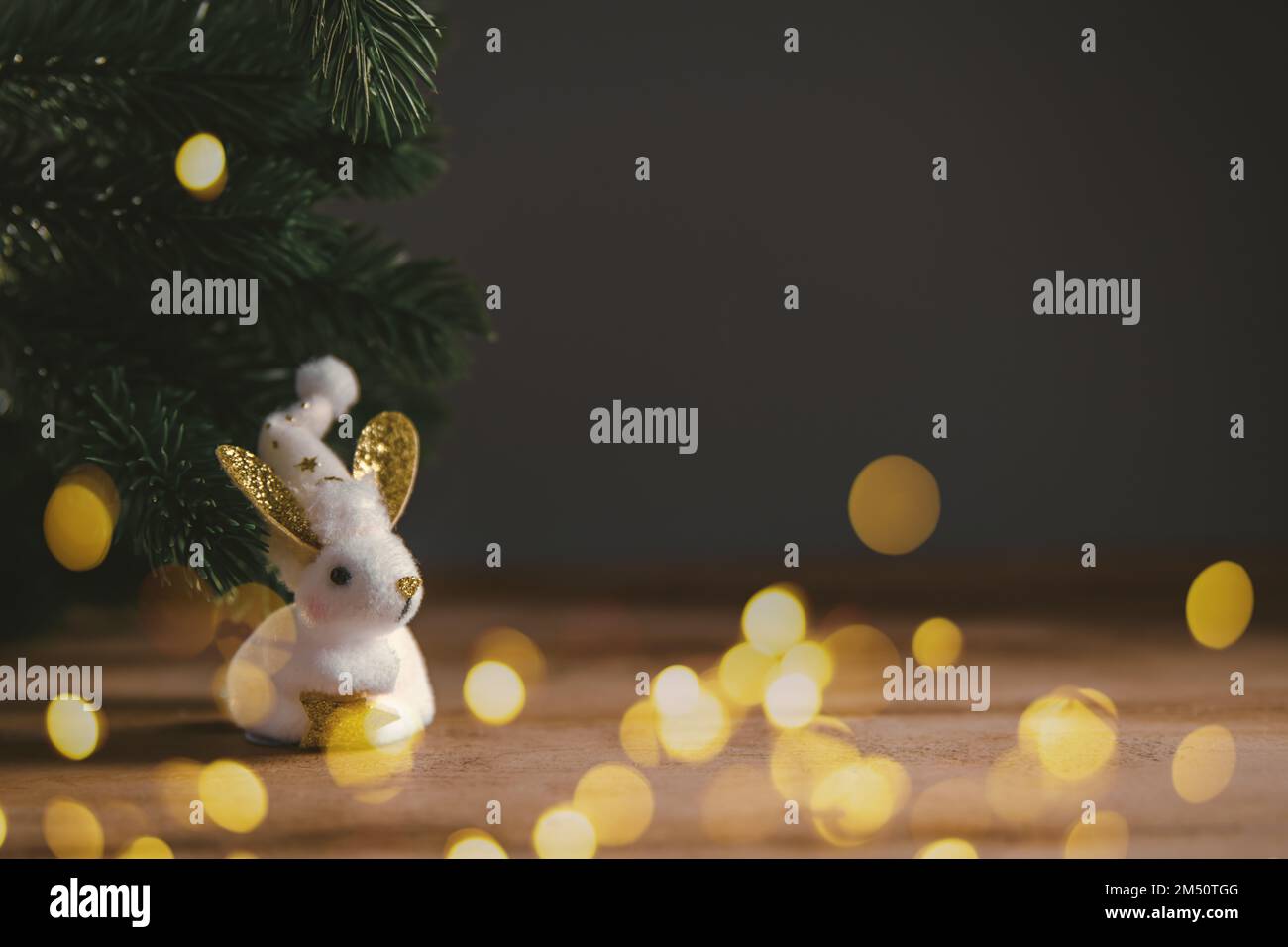 a rabbit symbol of 2023 among the lights, garlands, Christmas trees ...