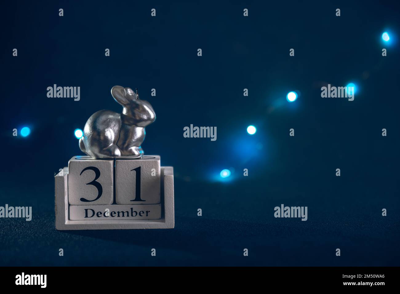 candle in the form of a rabbit symbol of 2023 among the lights ...