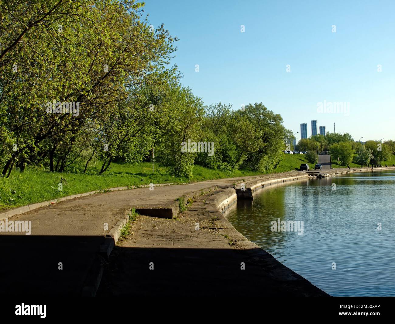 river embankment made of concrete slabs on a clear day, in summer Stock ...
