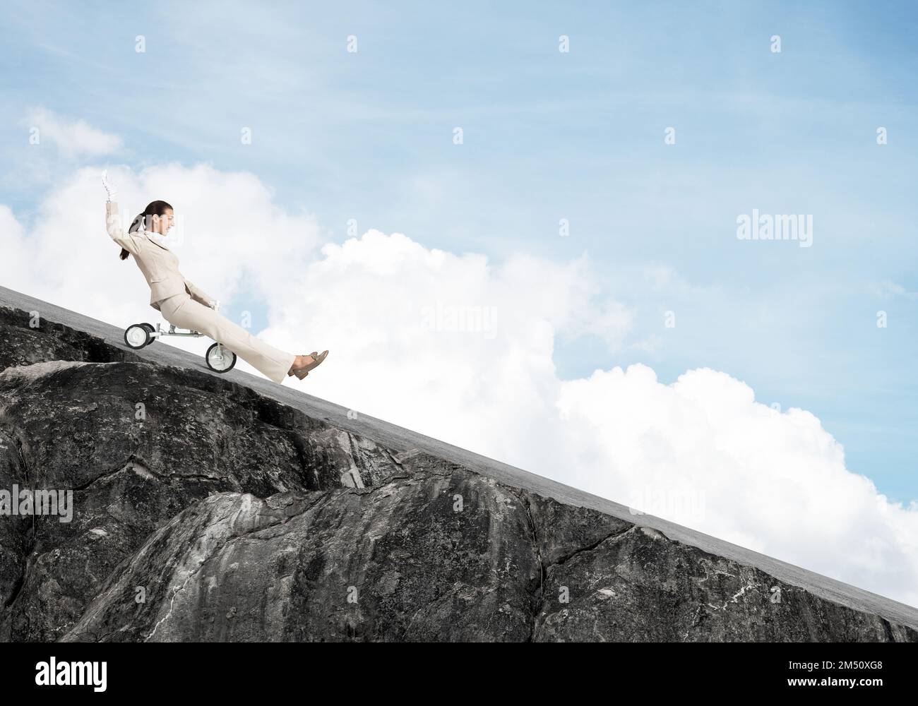 Beautiful happy woman riding downhill Stock Photo - Alamy