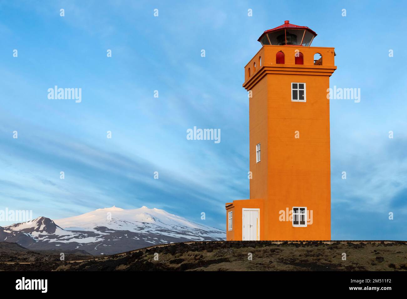 Svörtuloft Lighthouse, view of the lighthouse with a snow-capped ...
