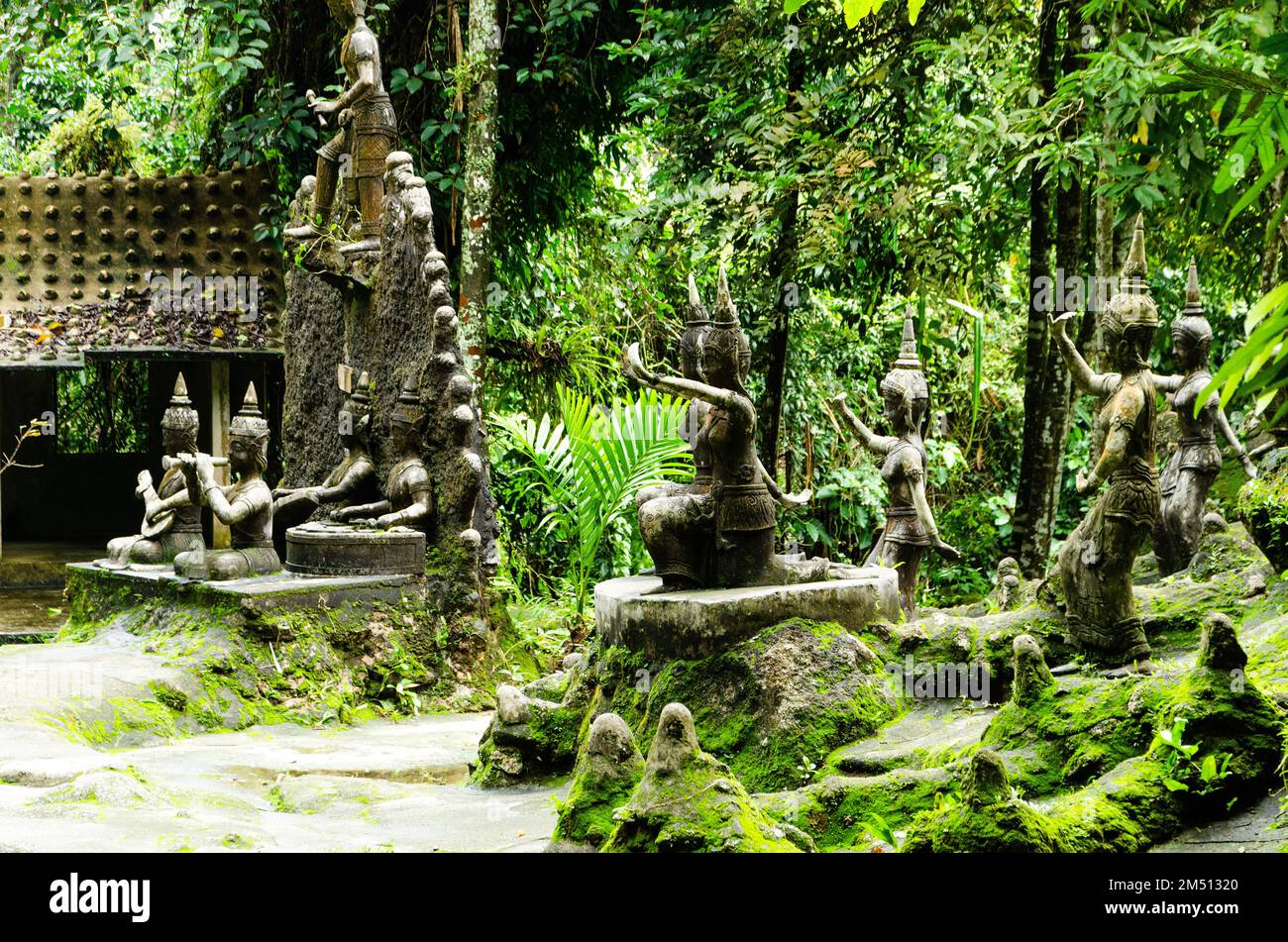 A vertical shot of ancient buddhist monk characters made out of stone ...