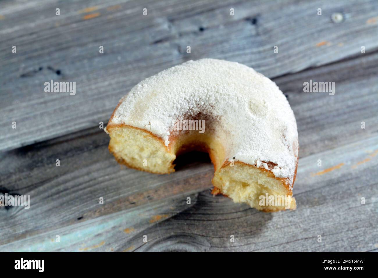 Powdered icing sugar ring donut, A glazed, yeast raised, American style ...