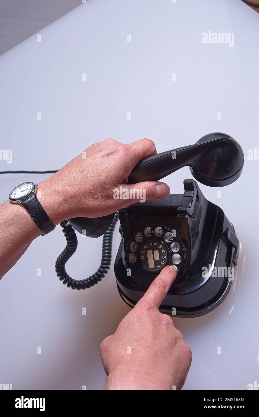 Male hands dial a phone number on a vintage rotary telephone Stock ...